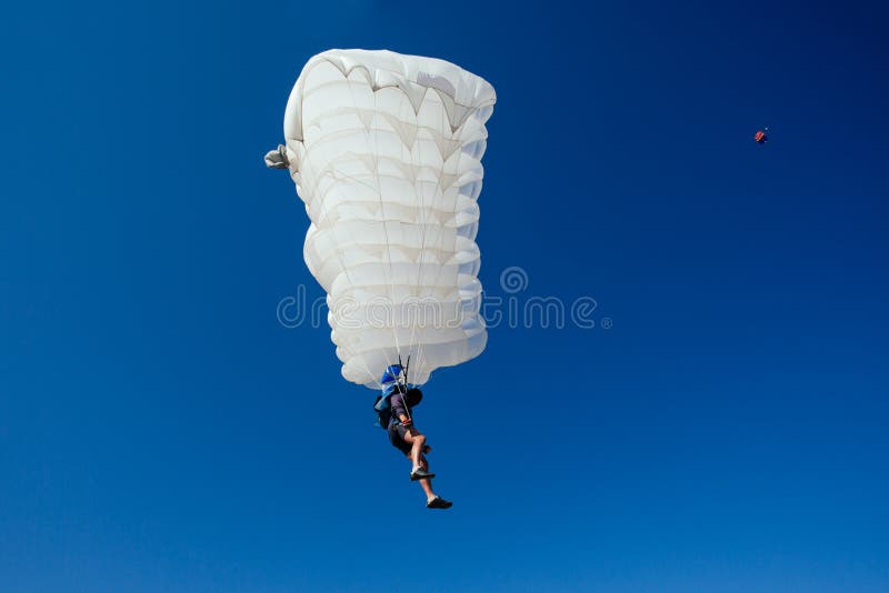 Parachute in the Sky. Skydiver is Flying a Parachute in the Blue Sky ...