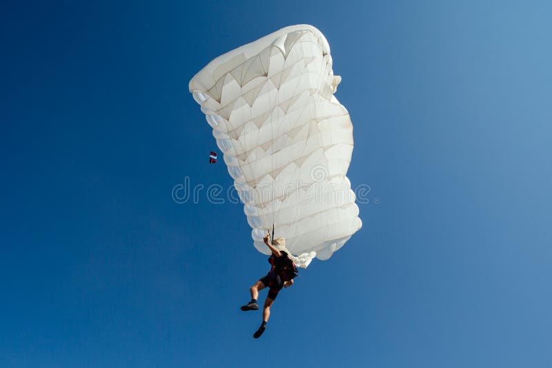 Parachute in the Sky. Skydiver is Flying a Parachute in the Blue Sky ...
