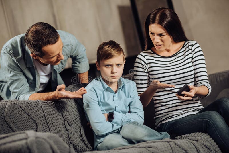 Young Parents Explaining Son about Drawbacks of Binge-playing Stock ...