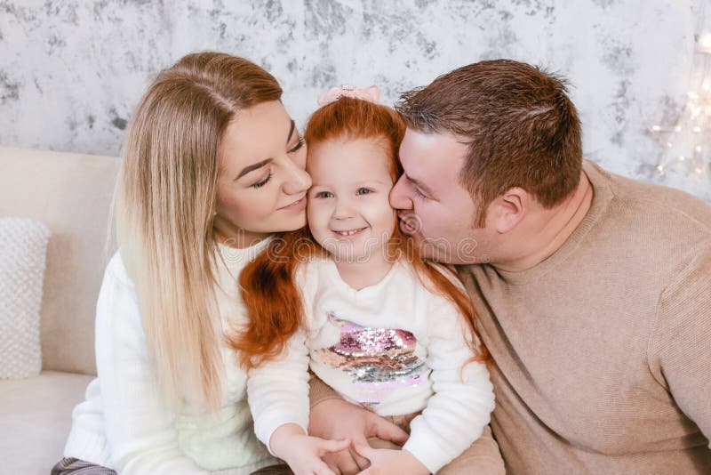 Young Parents Kissing Their Daughter in Christmas Stock Photo - Image ... Young Parents Kissing Their Daughter in Christmas Stock Photo - Image ...