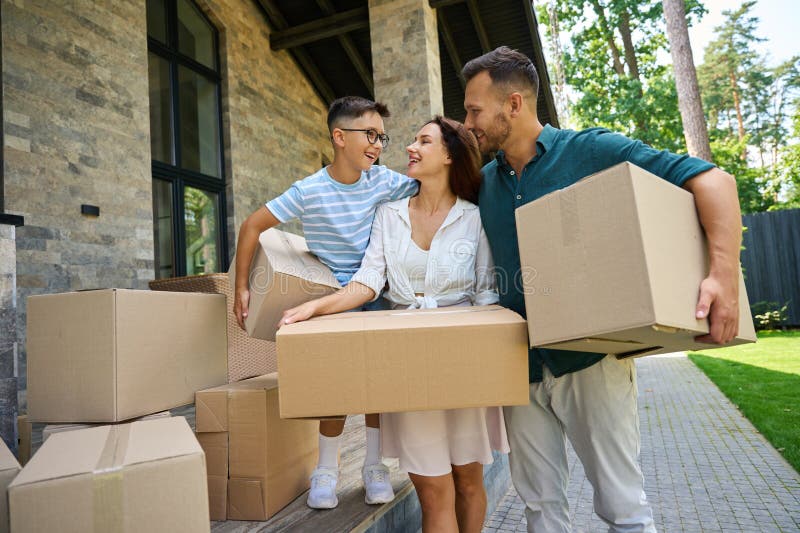 Young Parents and Their Son Move Boxes of Things Stock Photo - Image of ...