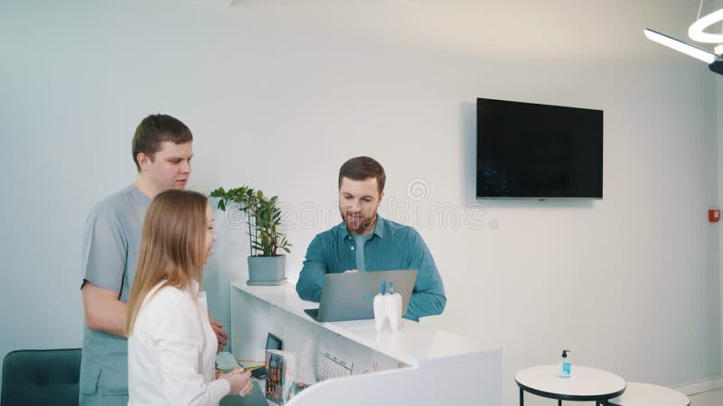 Young Patient Communicates with Doctors on the Reception Desk ...