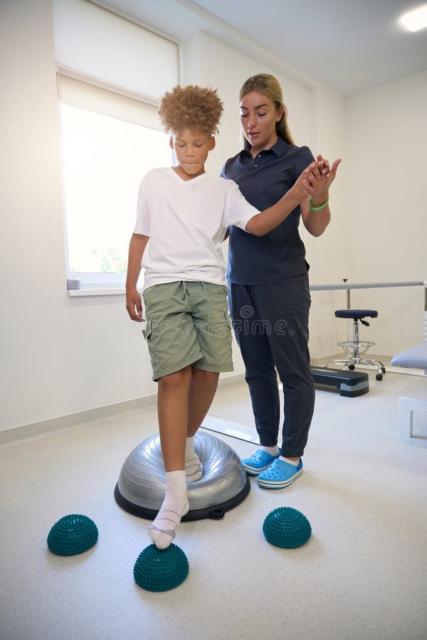 Young Patient Practices Maintaining Balance on an Unstable Surface Stock Image - Image of ...