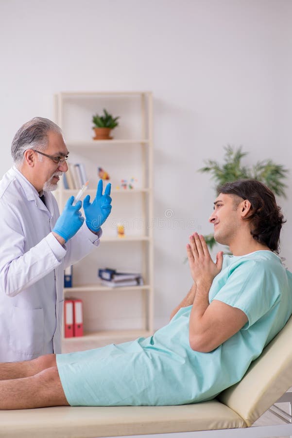 Young Male Patient Visiting Experienced Doctor Stock Photo - Image of ...
