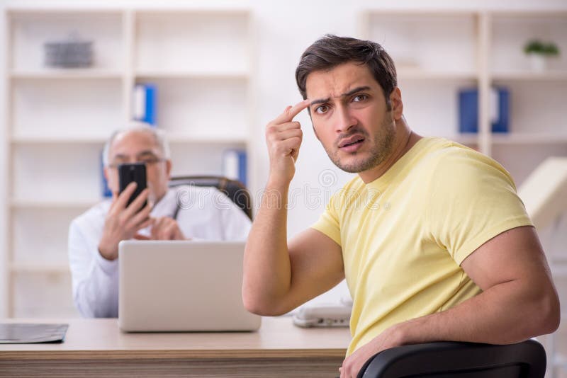 Young Male Patient Visiting Old Male Doctor Stock Image - Image of ... Young Male Patient Visiting Old Male Doctor Stock Image - Image of ...