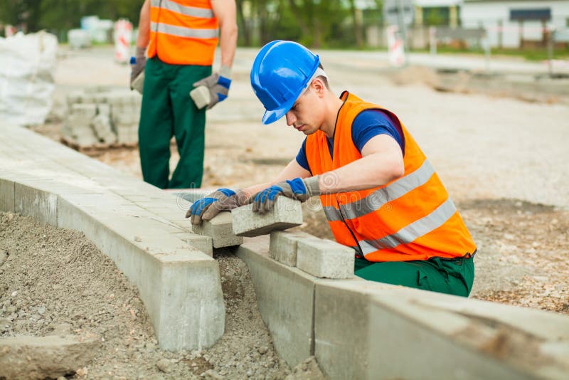 Young paver at work stock image. Image of pavement, concrete - 57092489