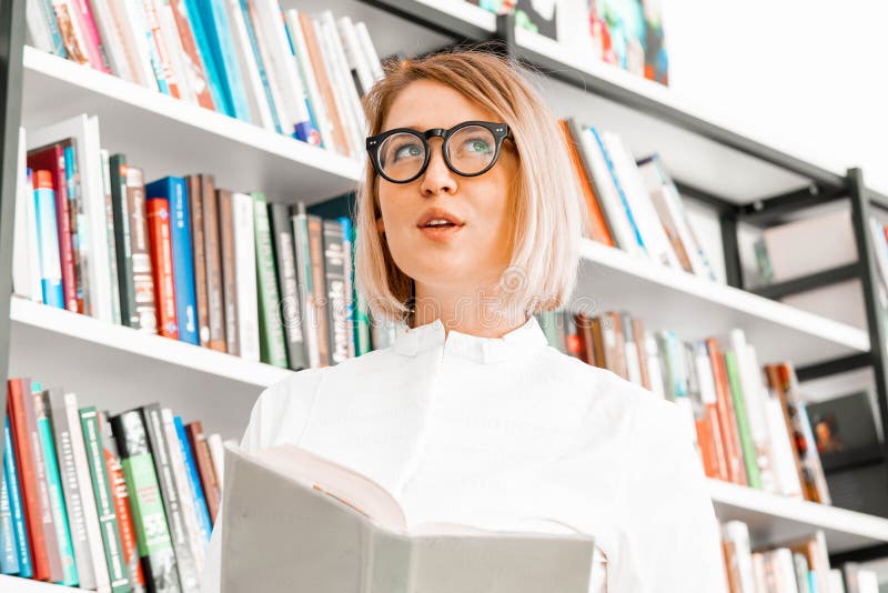 Young Pensive Attractive Woman in Formal Clothes Reading a Book at ...