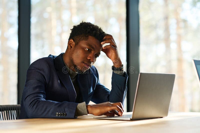 Young Pensive or Tense Businessman Sitting in Front of Laptop Stock ...