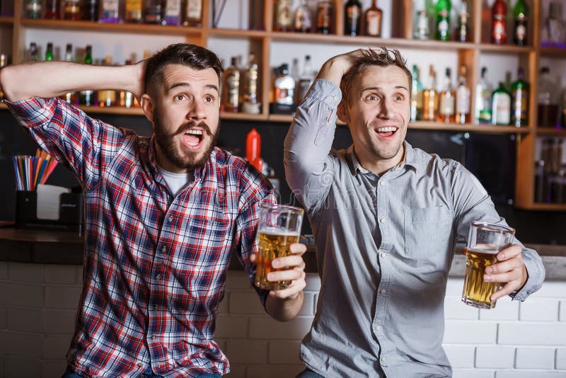 Young People with Beer Watching Football in a Bar Stock Image - Image ...