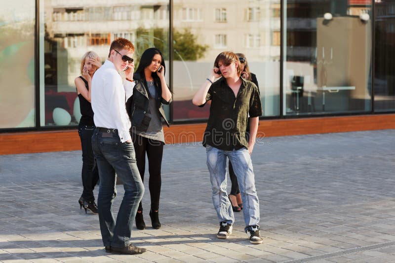Young Fashion People Calling on Cell Phones on the Street Stock Image ...