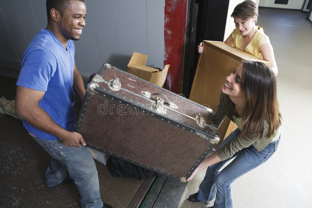 Young People Carrying Heavy Box on Moving Day. Stock Photo - Image of ...