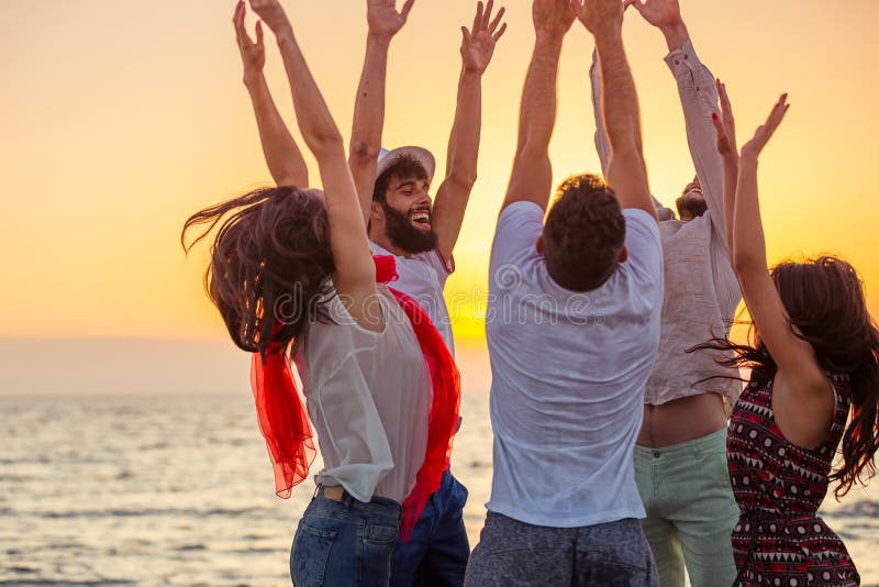 Young People Dancing on Beach at Sunset Stock Image - Image of beach ...
