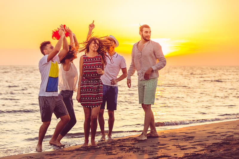 Young People Dancing on Beach at Sunset Stock Photo - Image of freedom ...