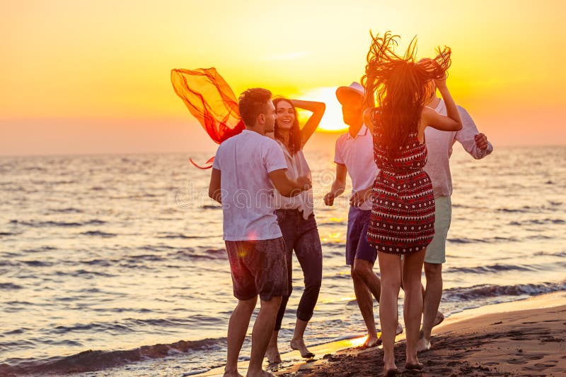 Young People Dancing on Beach at Sunset Stock Image - Image of party ...