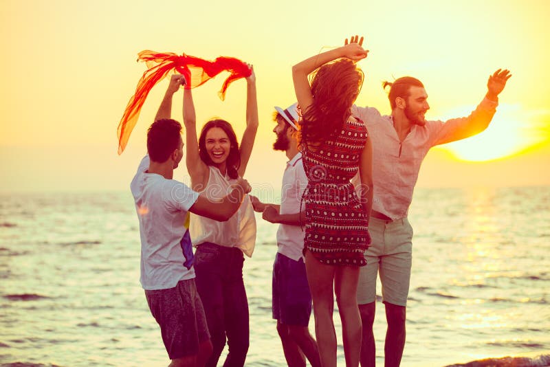Young People Dancing on Beach at Sunset Stock Image - Image of crowd ...
