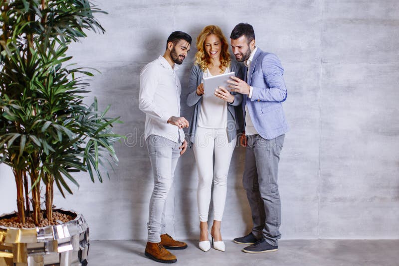 Young People with Digital Tablet by the Grey Wall Stock Image - Image ...