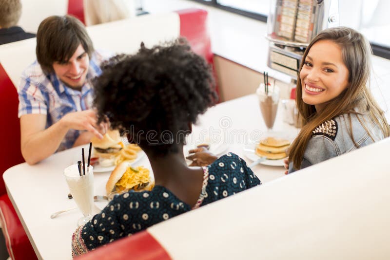 Young people in diner stock image. Image of food, burger - 78211869