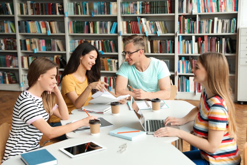 Young People Discussing Group Project at Table Stock Photo - Image of ...