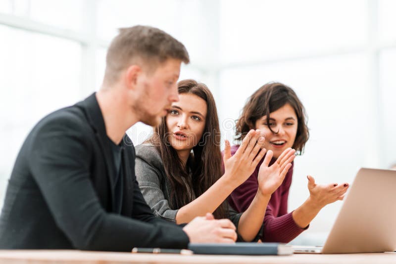 Young People Discussing Something Sitting at the Table Stock Photo ...