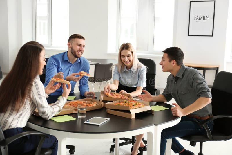 Young People Eating Pizza at Table in Office Stock Image - Image of ...