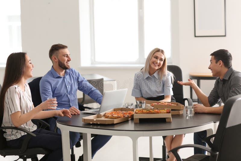 Young People Eating Pizza at Table in Office Stock Image - Image of ...