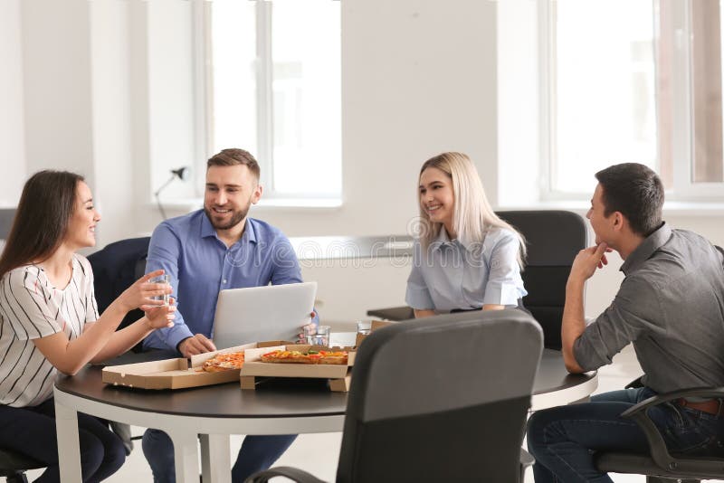 Young People Eating Pizza at Table in Office Stock Image - Image of ...