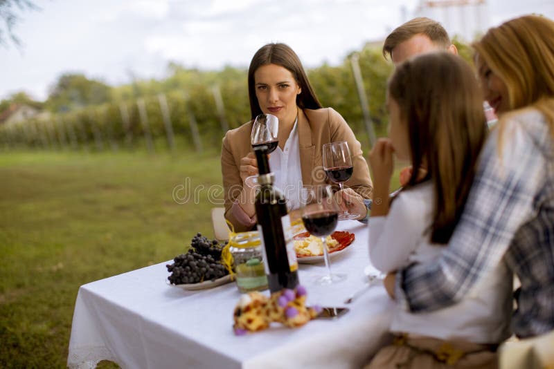 Young People Enjoy Dinner and Wine Tasting in the Vineyard Stock Photo ...