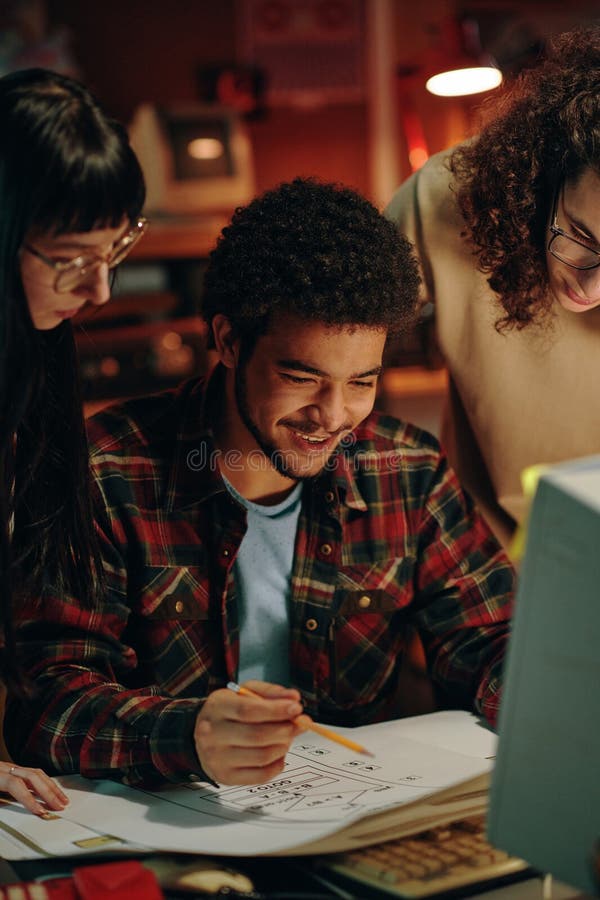 Young People Examining Blueprint Together Stock Image - Image of table ...