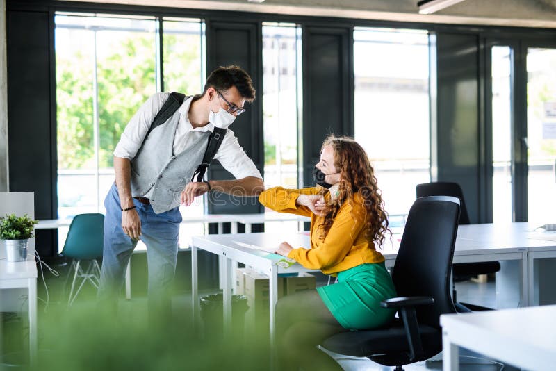 Young People with Face Masks Back at Work in Office after Lockdown ...
