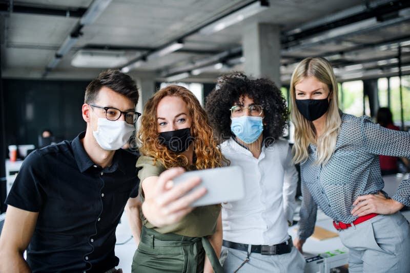 Young People with Face Masks Back at Work in Office after Lockdown ...