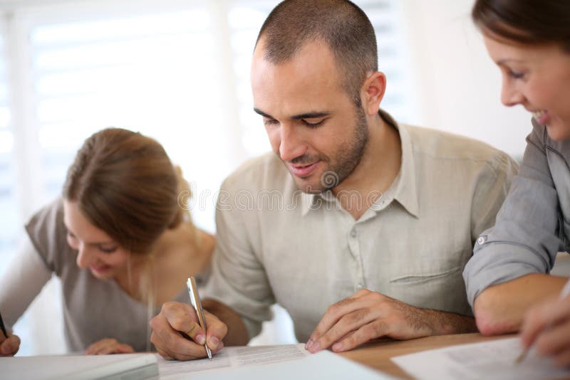 Young People Filling in Forms Stock Photo - Image of students ...