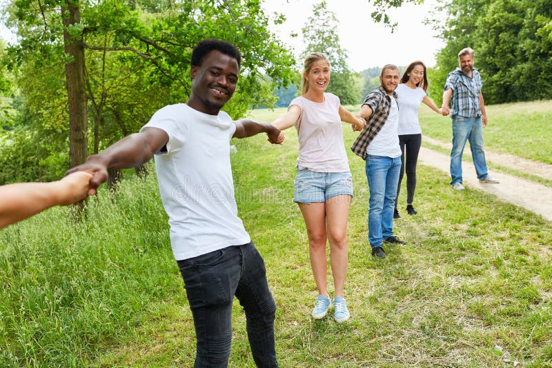 Young People Form a Human Chain Stock Photo - Image of summer, meadow ...
