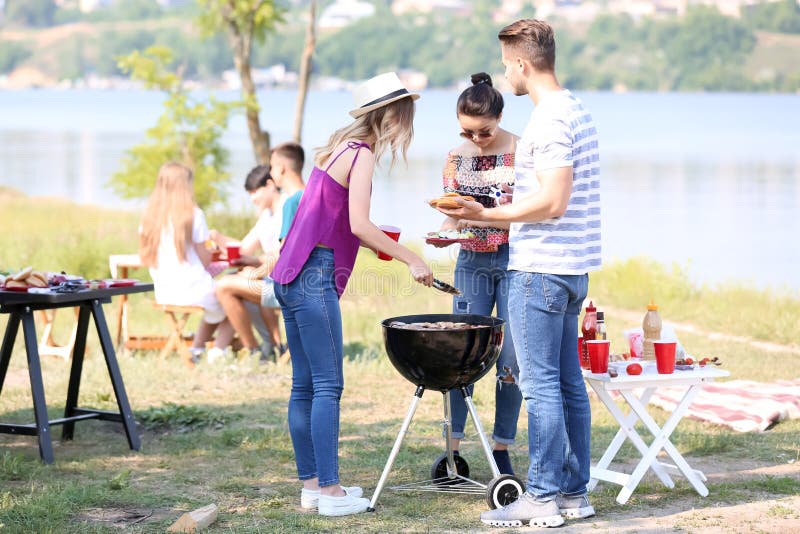 Young People Having Barbecue Party on Sunny Day Outdoors Stock Photo ...