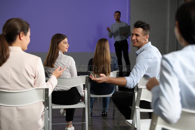 Young People Having Business Training in Room with Projection Screen ...