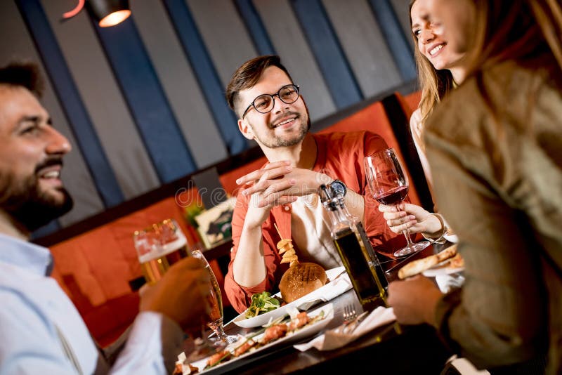 Young People Having Dinner in the Restaurant Stock Photo - Image of ...
