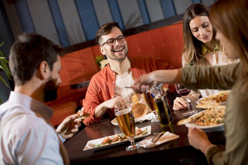 Young People Having Dinner in the Restaurant Stock Photo - Image of ...