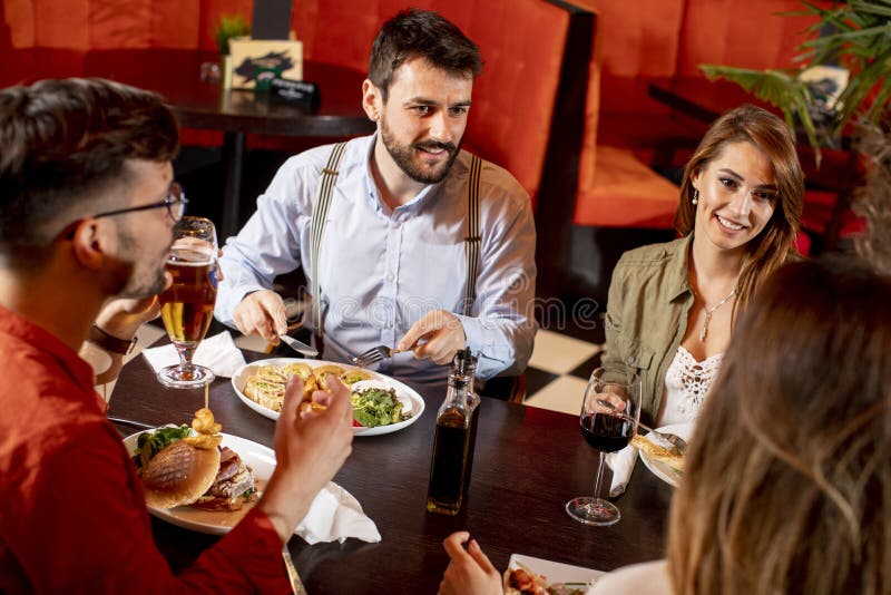 Young People Having Dinner in the Restaurant Stock Photo - Image of ...