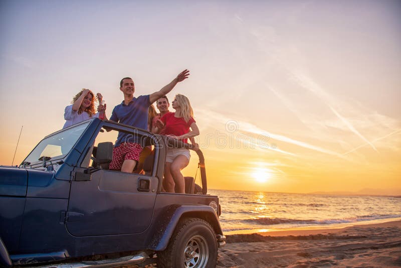 Young People Having Fun in Convertible Car at the Beach at Sunset ...