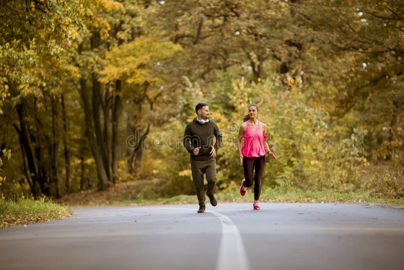 People Jogging and Exercising in Autumn Nature Enviroment Stock Photo ...