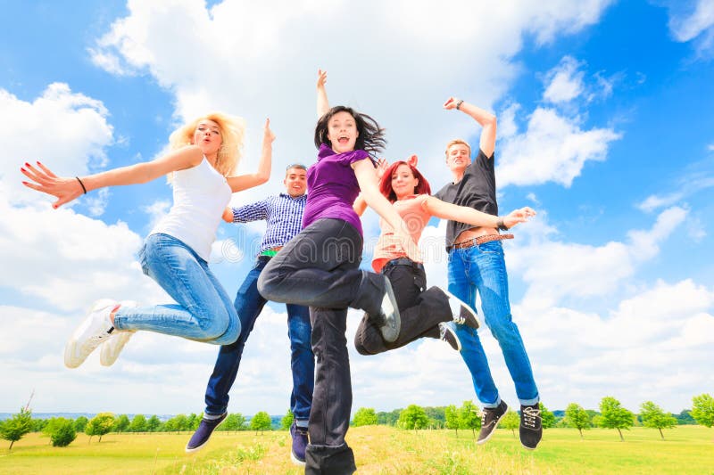 Young People Jumping stock photo. Image of field, meadow - 106061930
