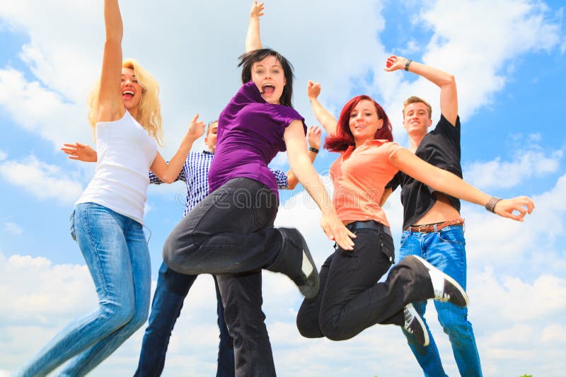 Young People Jumping in Front of Blue Sky Stock Photo - Image of ...