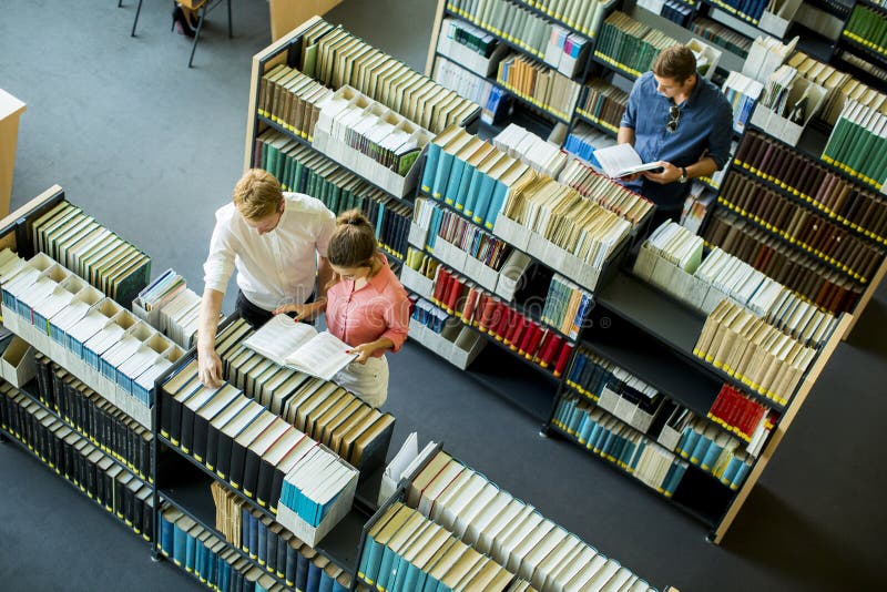 People in library aisle stock image. Image of academic - 20307361