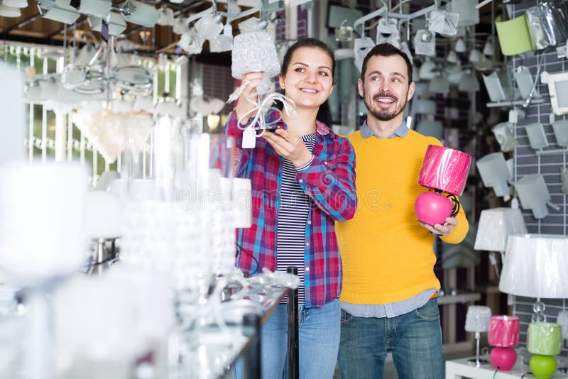 Young People Look at Table Lamps Stock Photo - Image of power, size ...