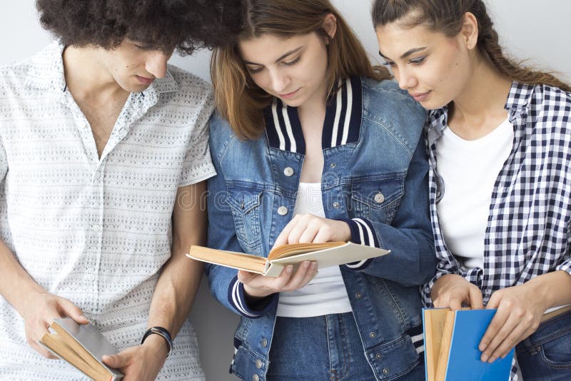 Young People Looking at a Book Stock Image - Image of group, friendship ...