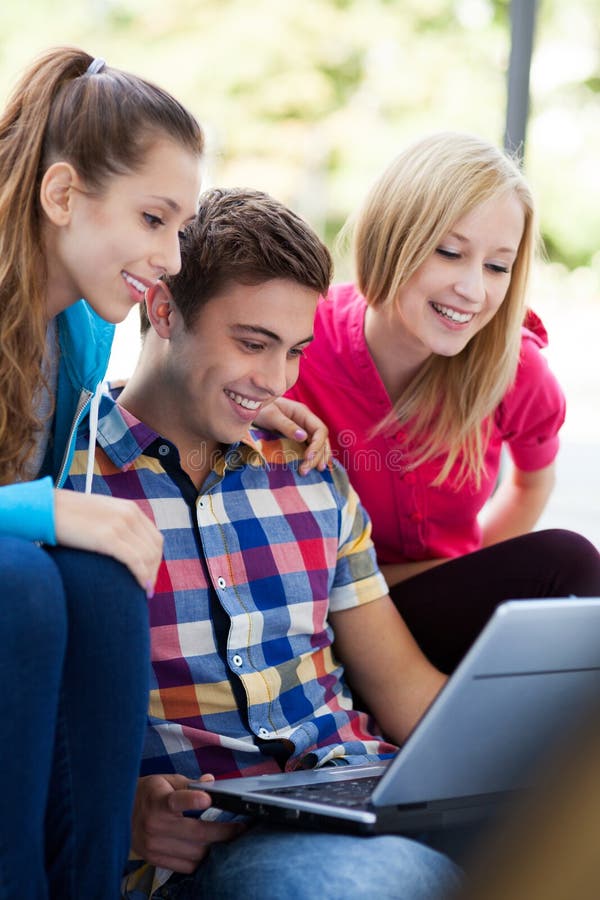 Young People Looking at Laptop Together Stock Photo - Image of cheerful ...