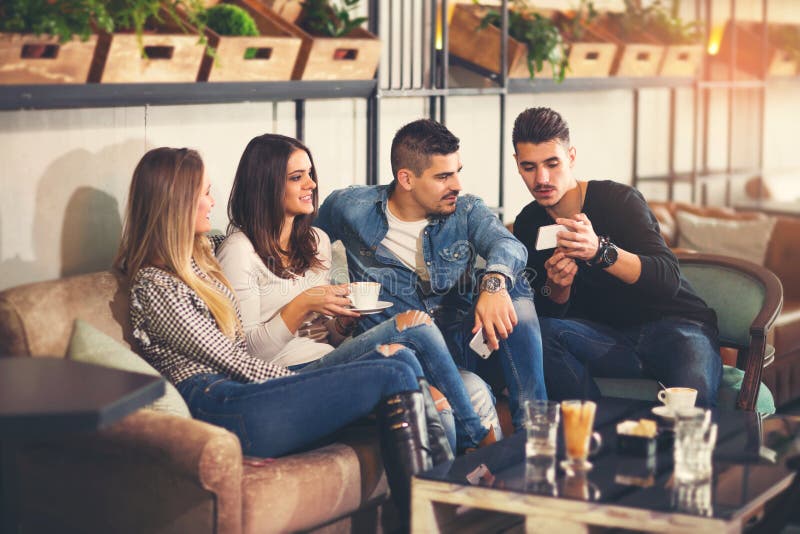 Young People Meeting in a Cafe. Stock Photo - Image of phone, male ...