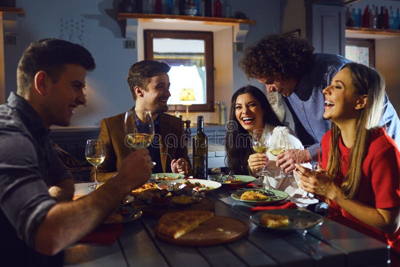 Young People Meeting Friends for Dinner in a Restaurant Stock Image ...