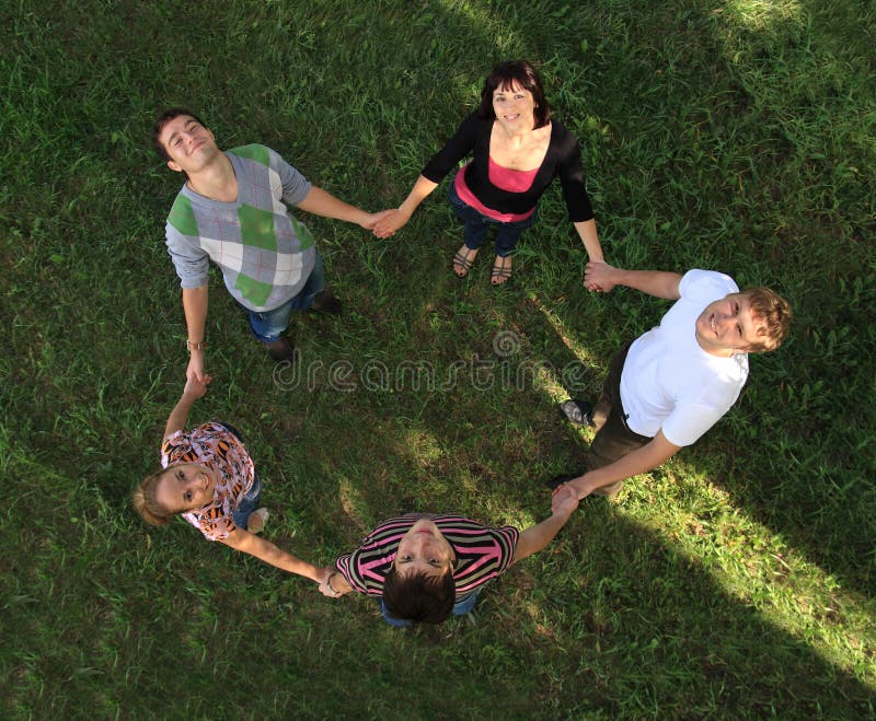Group of People in Huddle in Field Stock Photo - Image of blond, male ...