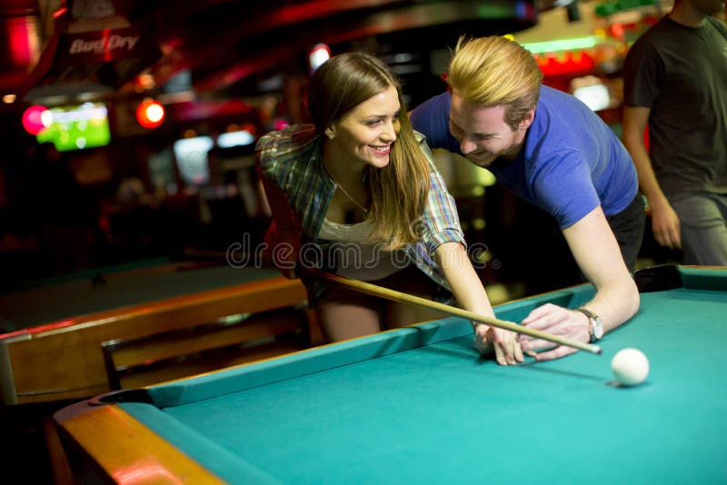 Young people playing pool stock image. Image of queue - 64242361