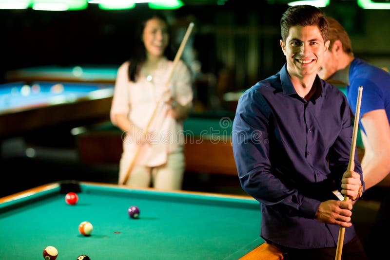 Young people playing pool stock photo. Image of nightlife - 53150108